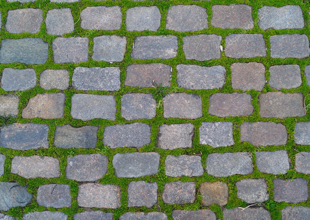 Granite pavement with grass sprouted Stock Photo by ©tka4ko 99908812