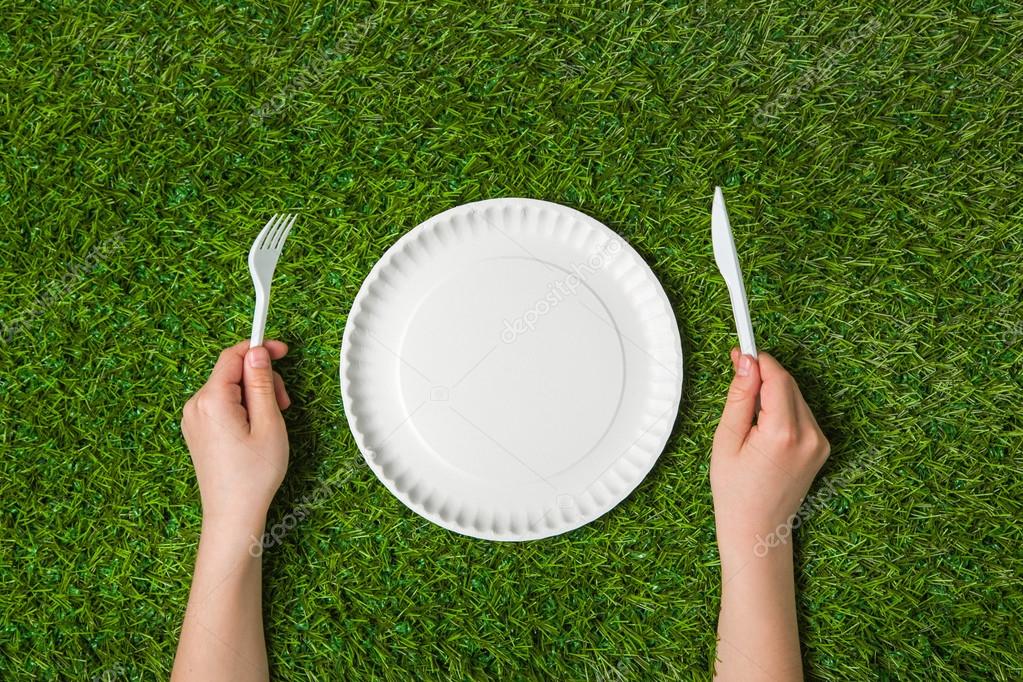 Hands holding fork and knife with plate on grass Stock Photo by ©r_tiom ...