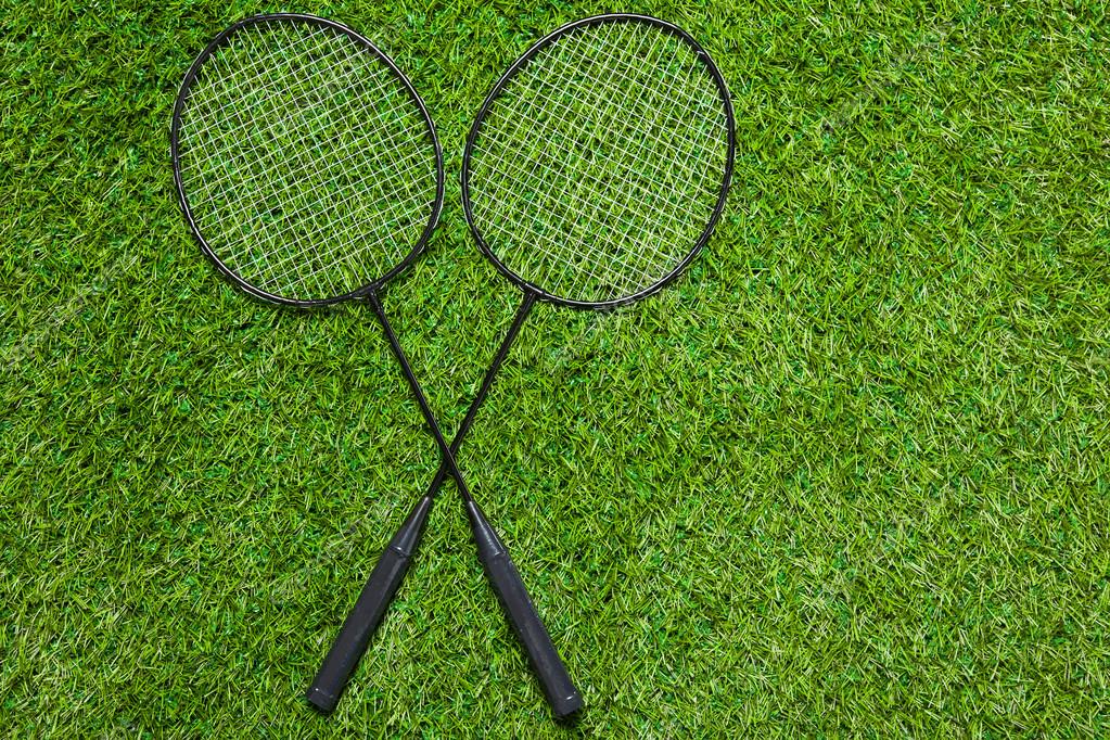 Two badminton rackets lying crossed on the grass ⬇ Stock Photo, Image ...