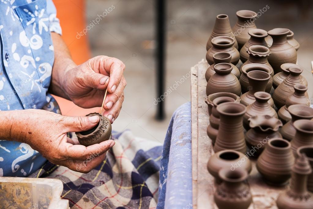 Workers producing handmade art vase earthenware at market. Stock Photo ...