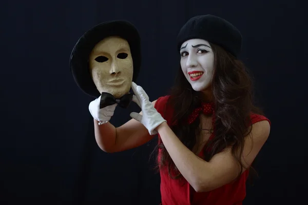 A brunette girl holding a white theatrical mask and cries — Stock Photo ...