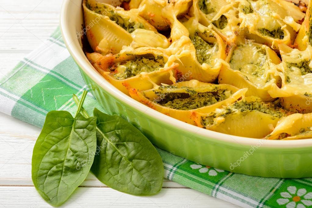 Italian cuisine - pasta shells stuffed with spinach, ricotta and baked ...