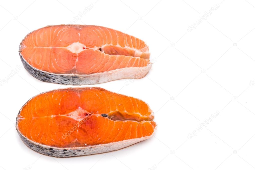 Comparison between wild and farmed salmon blocks on white background ...