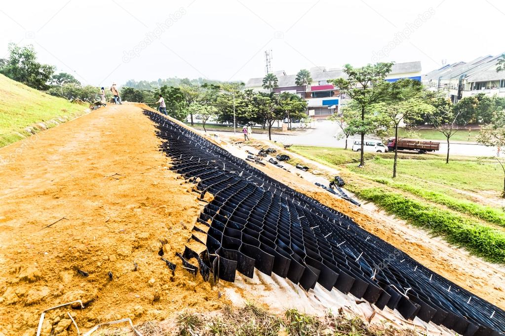 Slope erosion control with grids and earth on steep slope Stock Photo ...