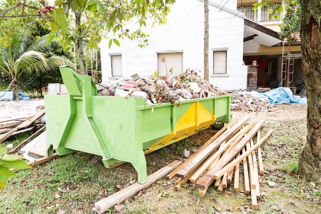 Construction rubbish bin with loads at construction site. Stock Photo ...