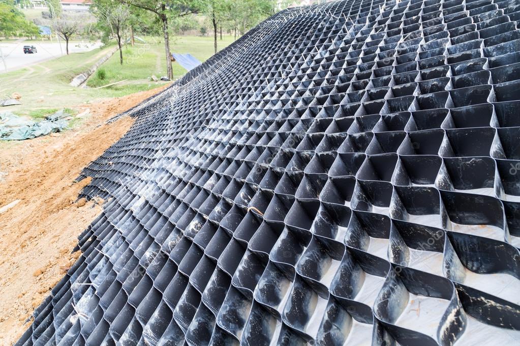 Close up on slope erosion control grids on steep slope. Stock Photo by ...