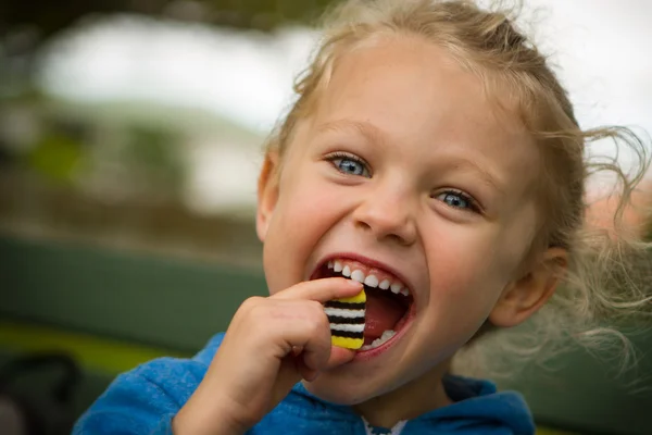 Blue eyed girl eating sweets Pictures, Blue eyed girl eating sweets ...