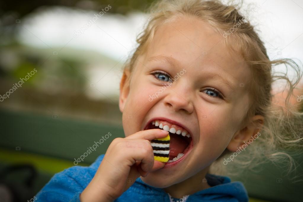 Young child eating sweets ⬇ Stock Photo, Image by © taonga #111280102
