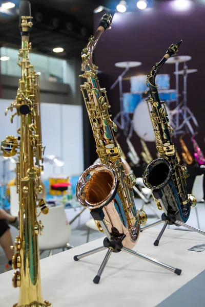 Shiny saxophones in raw is standing in the stand, hobby, music ...