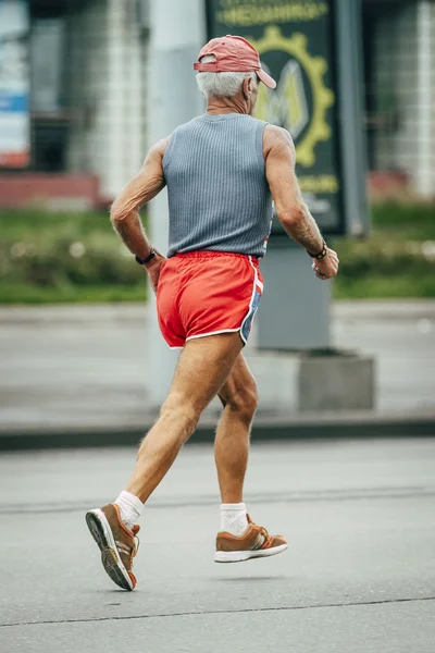 Old man runs marathon - Stock Image - Everypixel