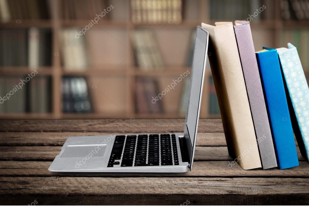 Stack of books with laptop Stock Photo by ©billiondigital 114728746
