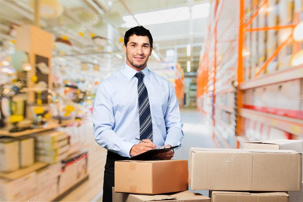 Man filling paper at warehouse Stock Photo by ©billiondigital 118539828