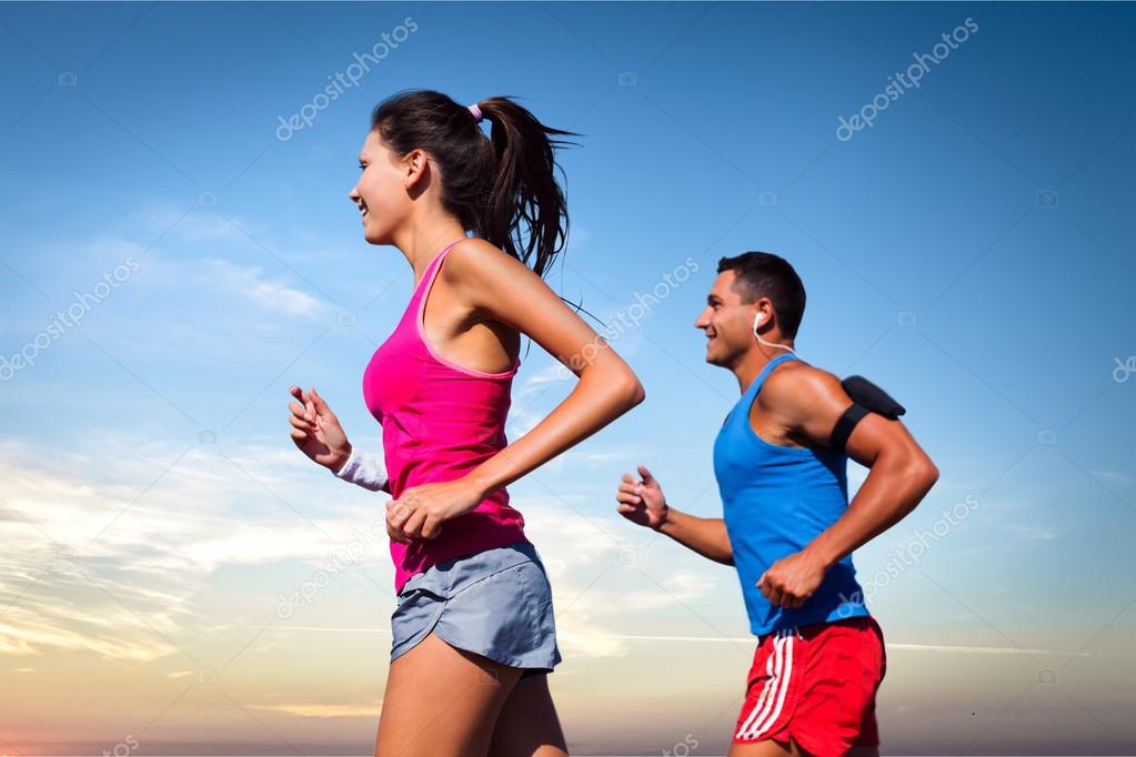 Smiling couple running together Stock Photo by ©billiondigital 118539900