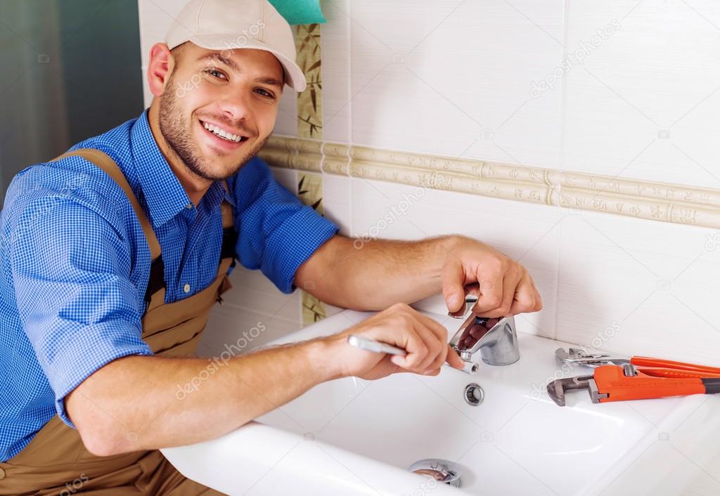 Plumber hands fixing water tap — Stock Photo © billiondigital #118560596
