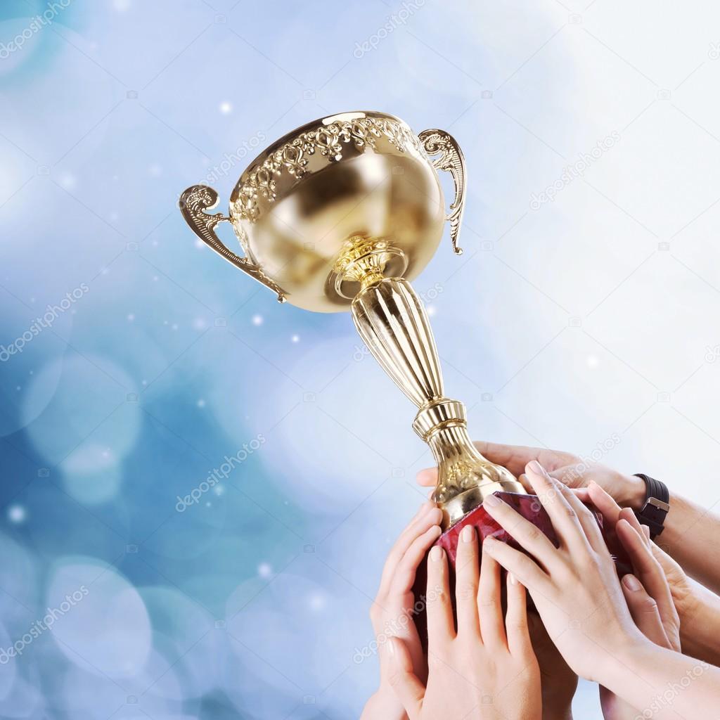 Hand Holding Trophy