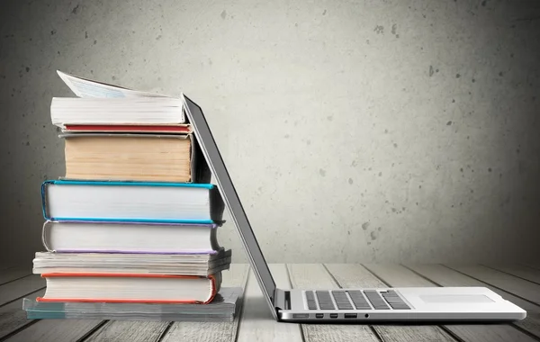 Stack of books with laptop — Stock Photo © billiondigital #118714404