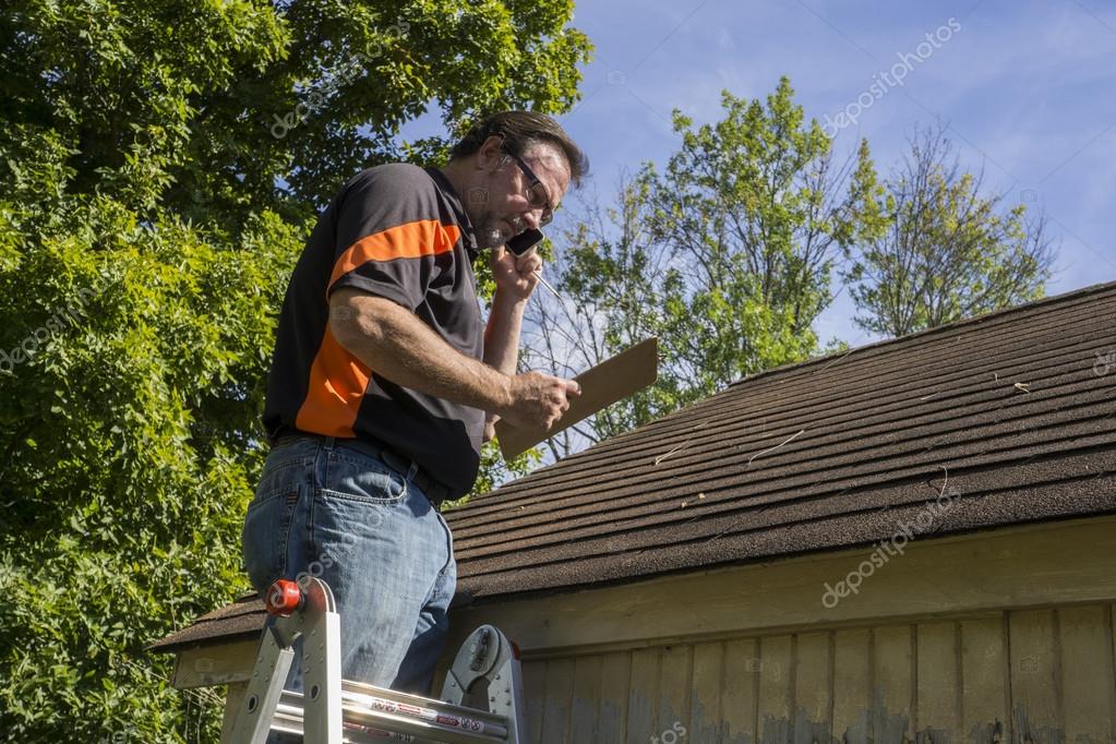 Contractor On Ladder Figuring Hail Damage Repairs To Roof — Stock Photo ...