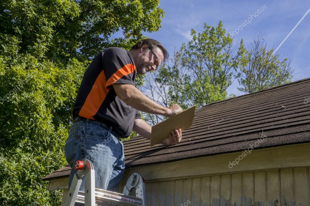 Contractor On Ladder Figuring Hail Damage Repairs To Roof — Stock Photo ...