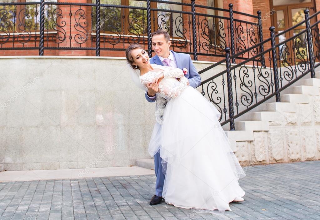 Beautiful caucasian couple just married and dancing their first dance ...