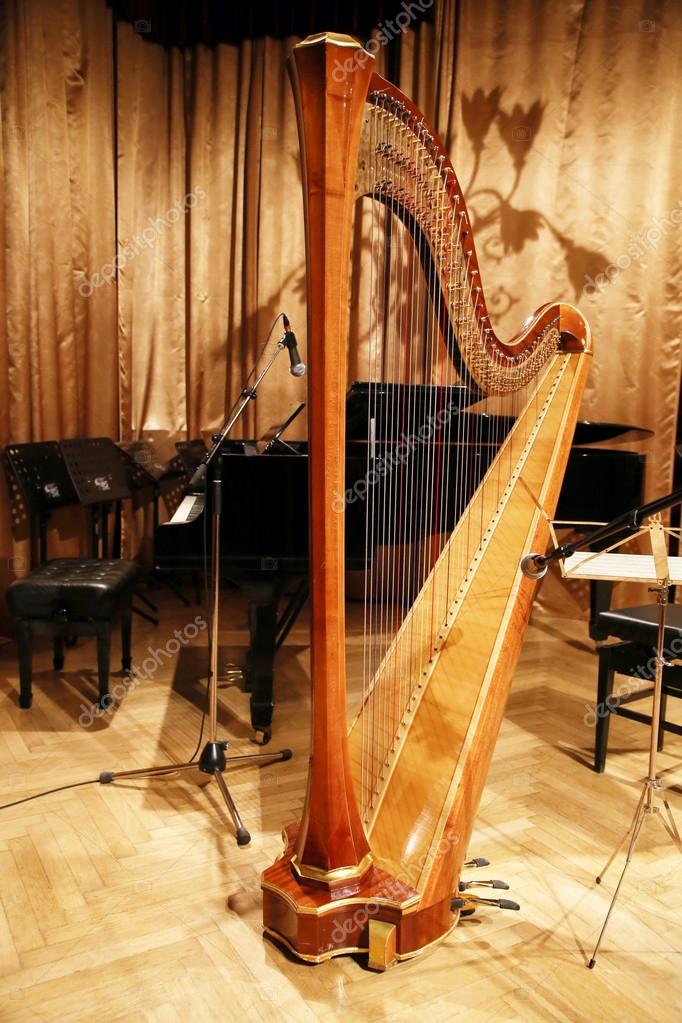 Beautiful golden harp in the auditorium before concert Stock Photo by ...