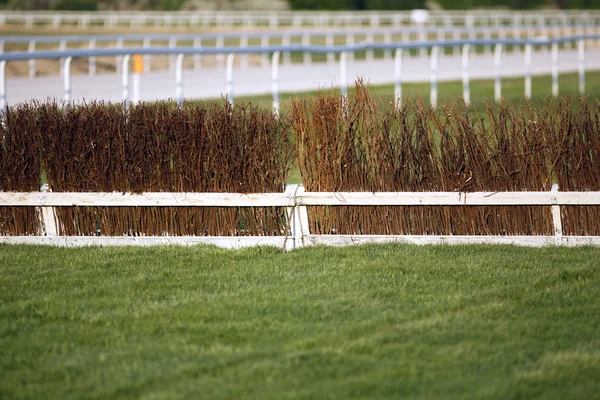 Fence as obstacle for racehorses on race course Stock Photo by ...