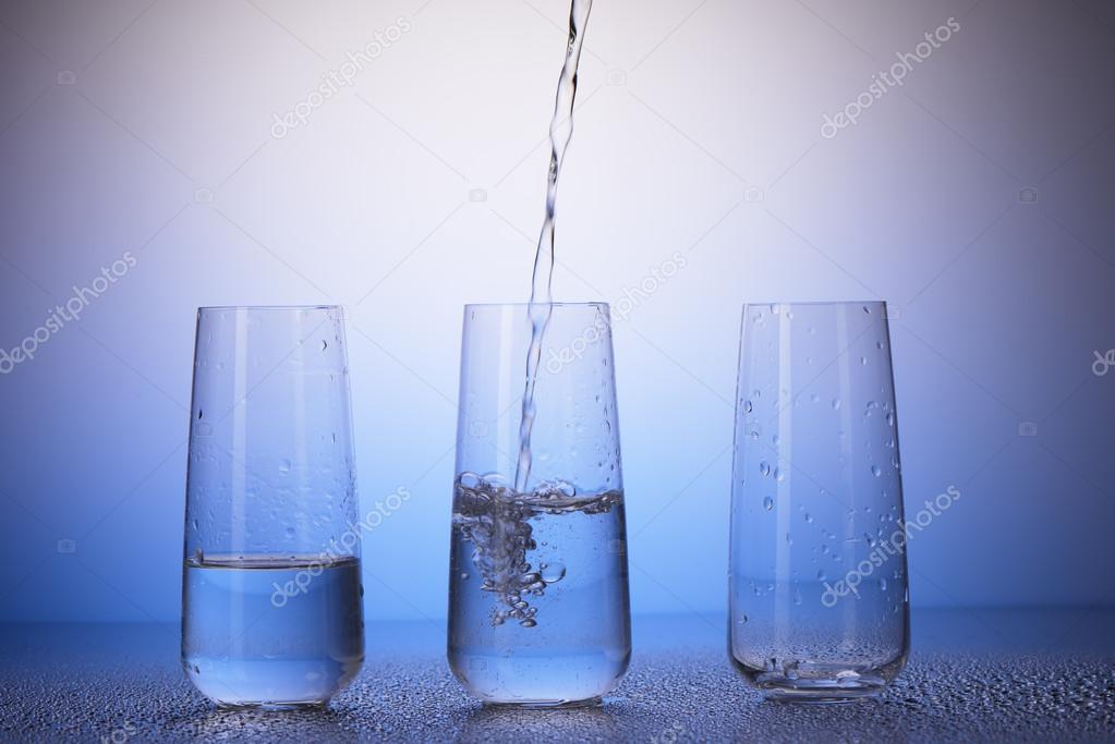 One-third full, half-filled, empty drinking glasses, water Stock Photo ...