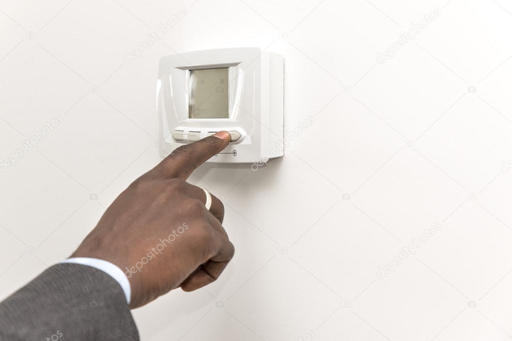 Hand push button digital climate control Stock Photo by ©santypan 72673277