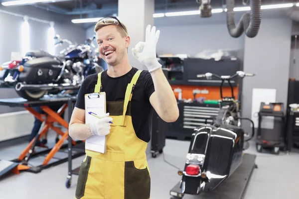 Master locksmith makes ok gesture with his hand and stands at car ...