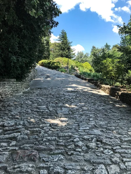 The path in the park is paved with stone. Decorative trail or road in ...