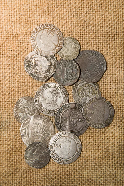 Ancient silver coins with portraits of kings on the old cloth - Stock ...