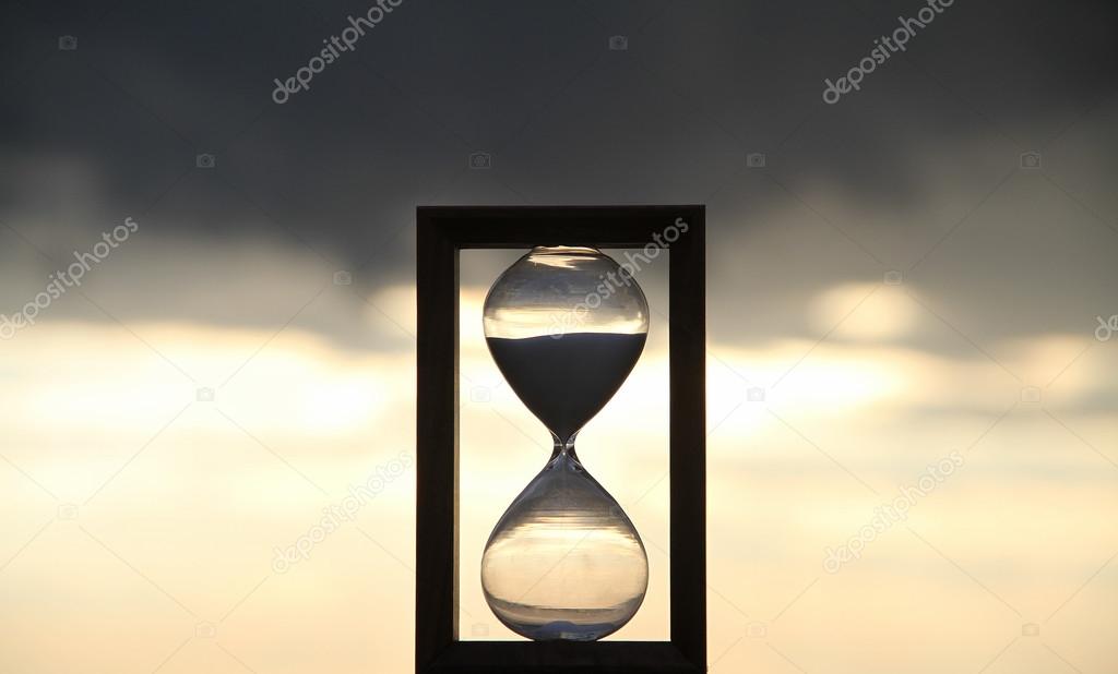 Time glass on concrete parapet over dark sky Stock Photo by ...