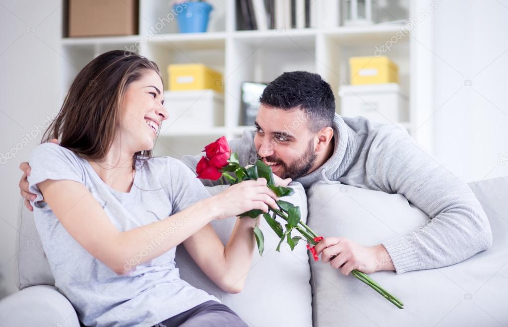 Young man giving a red rose to his girlfriend Stock Photo by ©Nikodash ...