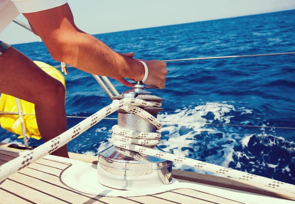 Sailing crew member pulling rope - Stock Image - Everypixel