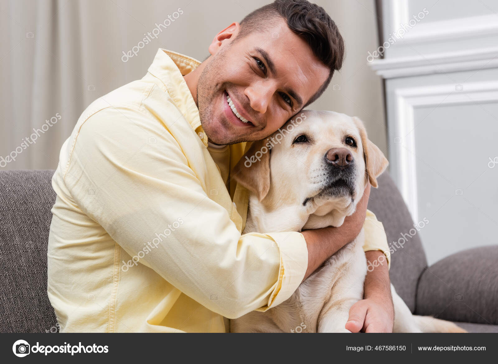 Pleased Man Smiling Camera While Cuddling Labrador Home — Stock Photo ...
