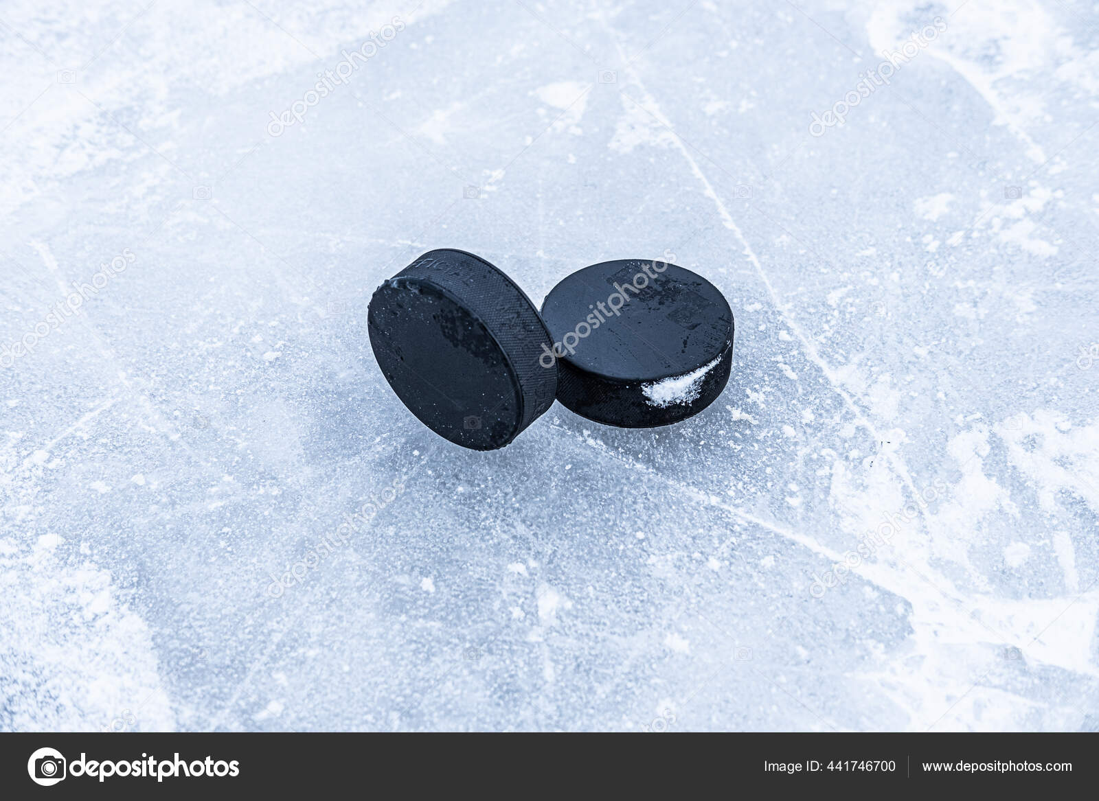 Two Pucks Laying Ice — Stock Photo © rokokoev #441746700