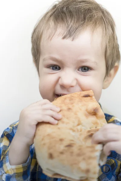 Hungry child eating bread — Stock Photo © maximilian100 #62117615