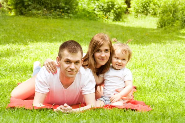 Happy mother, father and daughter in the park — Stock Photo © suravid ...