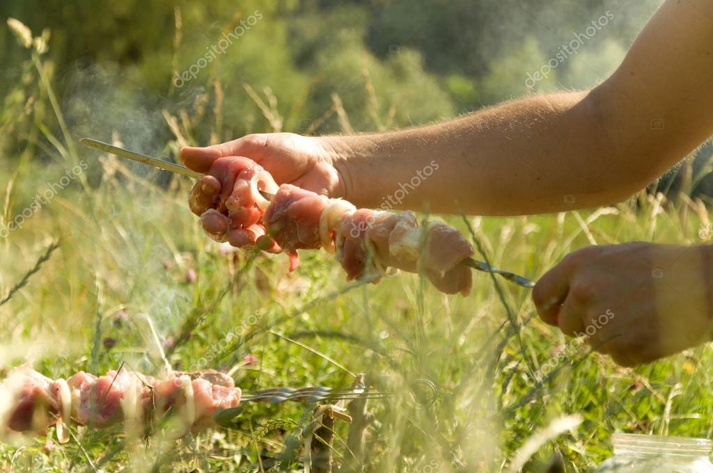 Man stringing meat on a skewer Stock Photo by ©annadanilkova 77346562