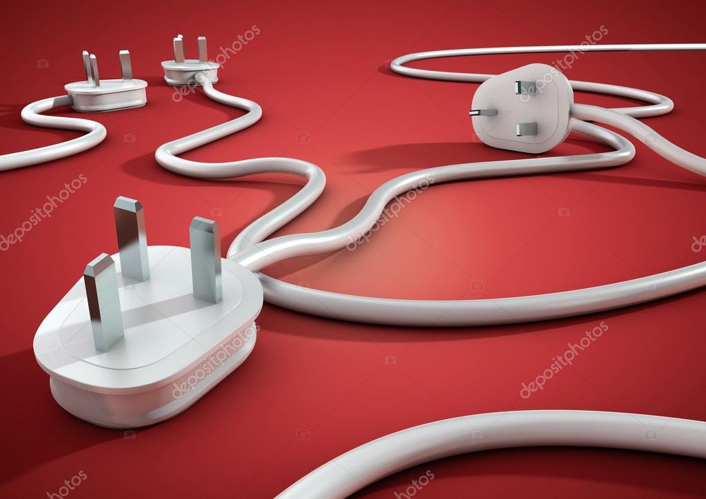 Electical cables and plugs lay on a red smooth surface and overlap each ...