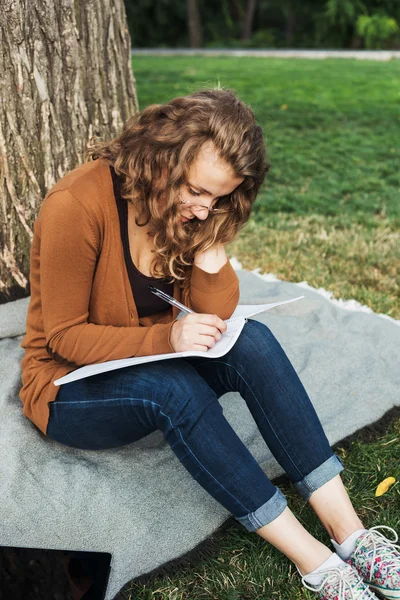 Young caucasian female student with books on campus, student study in ...