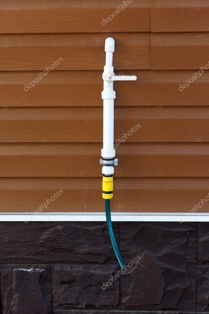 Polypropylene pipe with a tap on siding wal — Stock Photo © hdmphoto ...