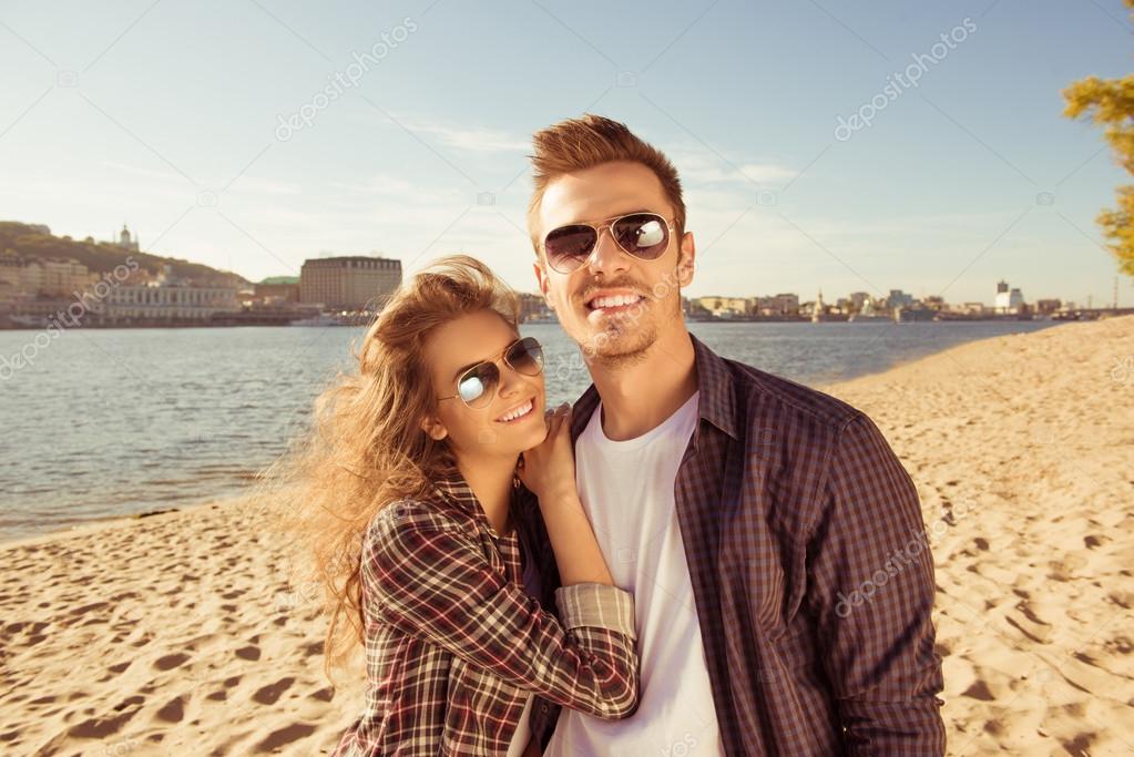 Young hipster couple hugging each other near the river Stock Photo by ...