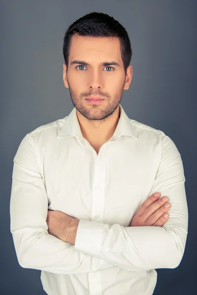 Serious young man with cross hands - Stock Image - Everypixel