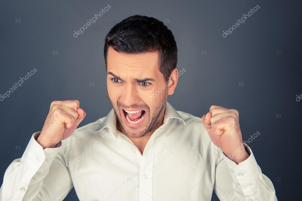 Handsome depressed man in rage Stock Photo by ©deagreez1 111990076