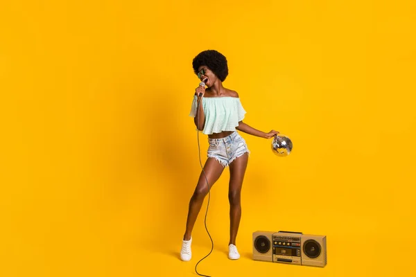 Full length body size photo of black skinned girl singing with boombox ...