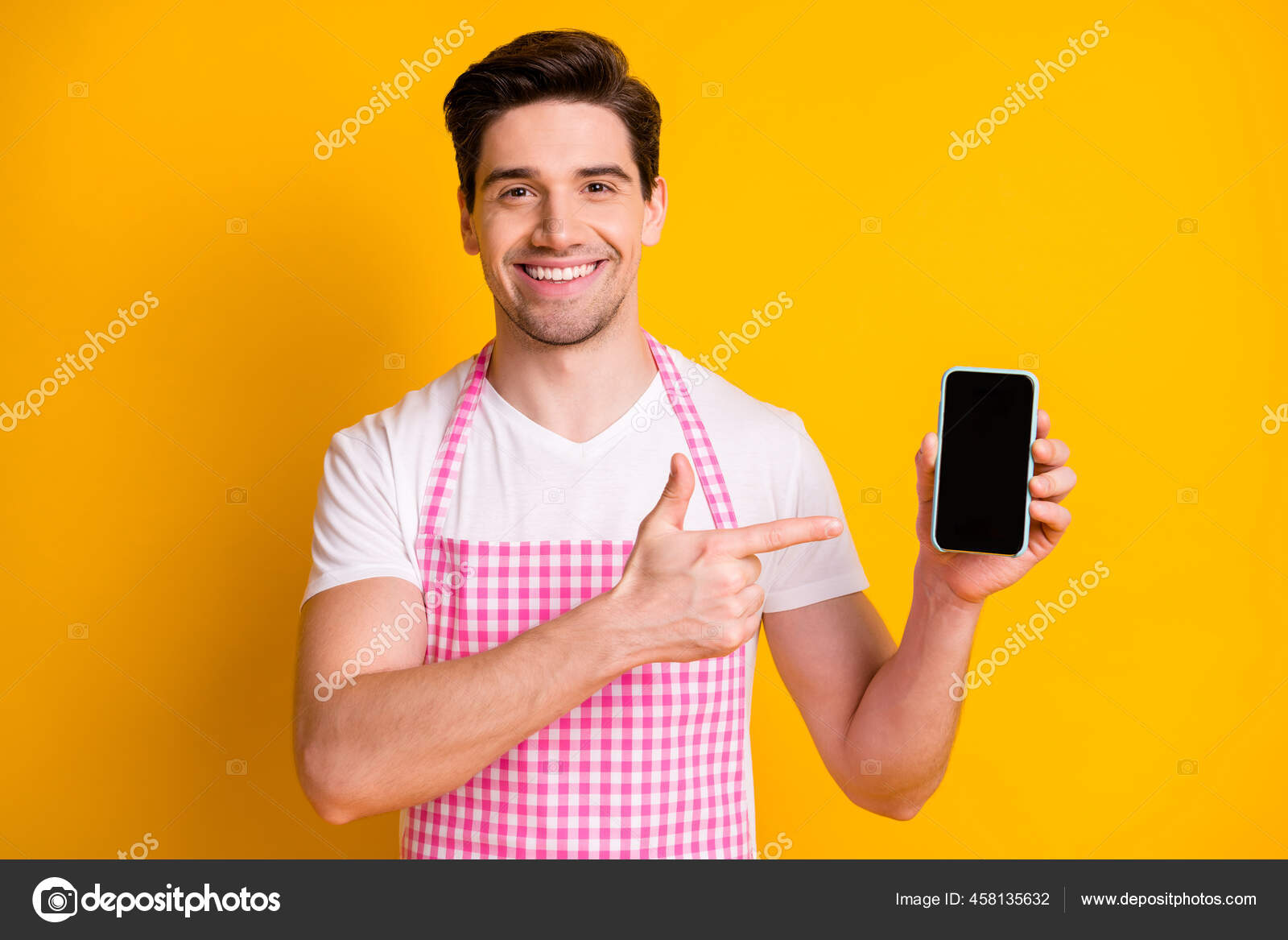 Photo portrait of guy pointing finger at showing phone with blank space ...