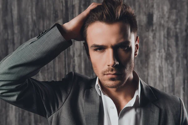 Attractive rigid man in business suit on the grey background Stock ...