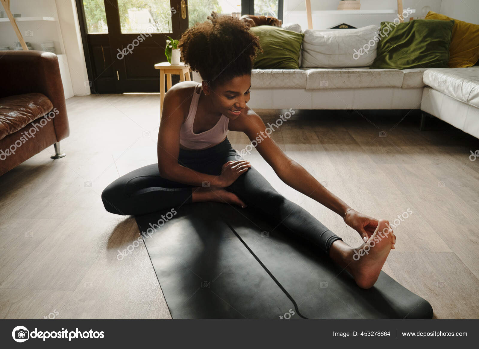 Beautiful female stretching hamstrings during yoga practice exercising ...