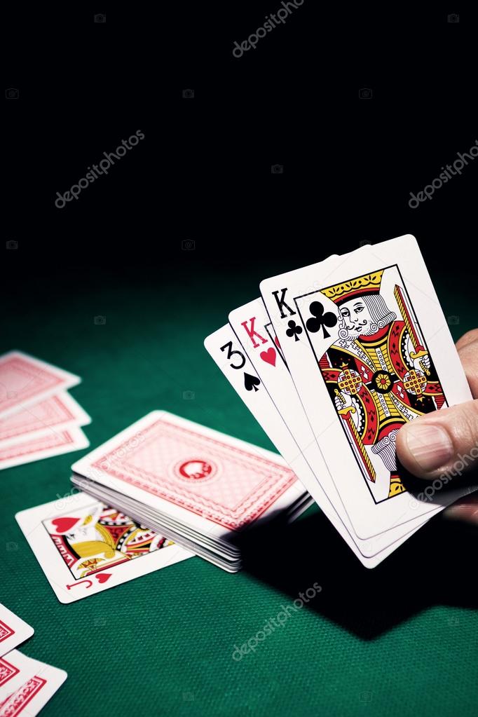 Man's hand with cards Stock Photo by ©diogoppr 69750375