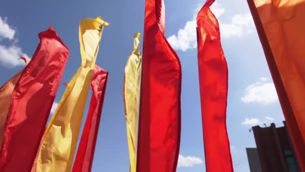 Atlas flags filmed from below are trembling by the wind on a blue sky ...